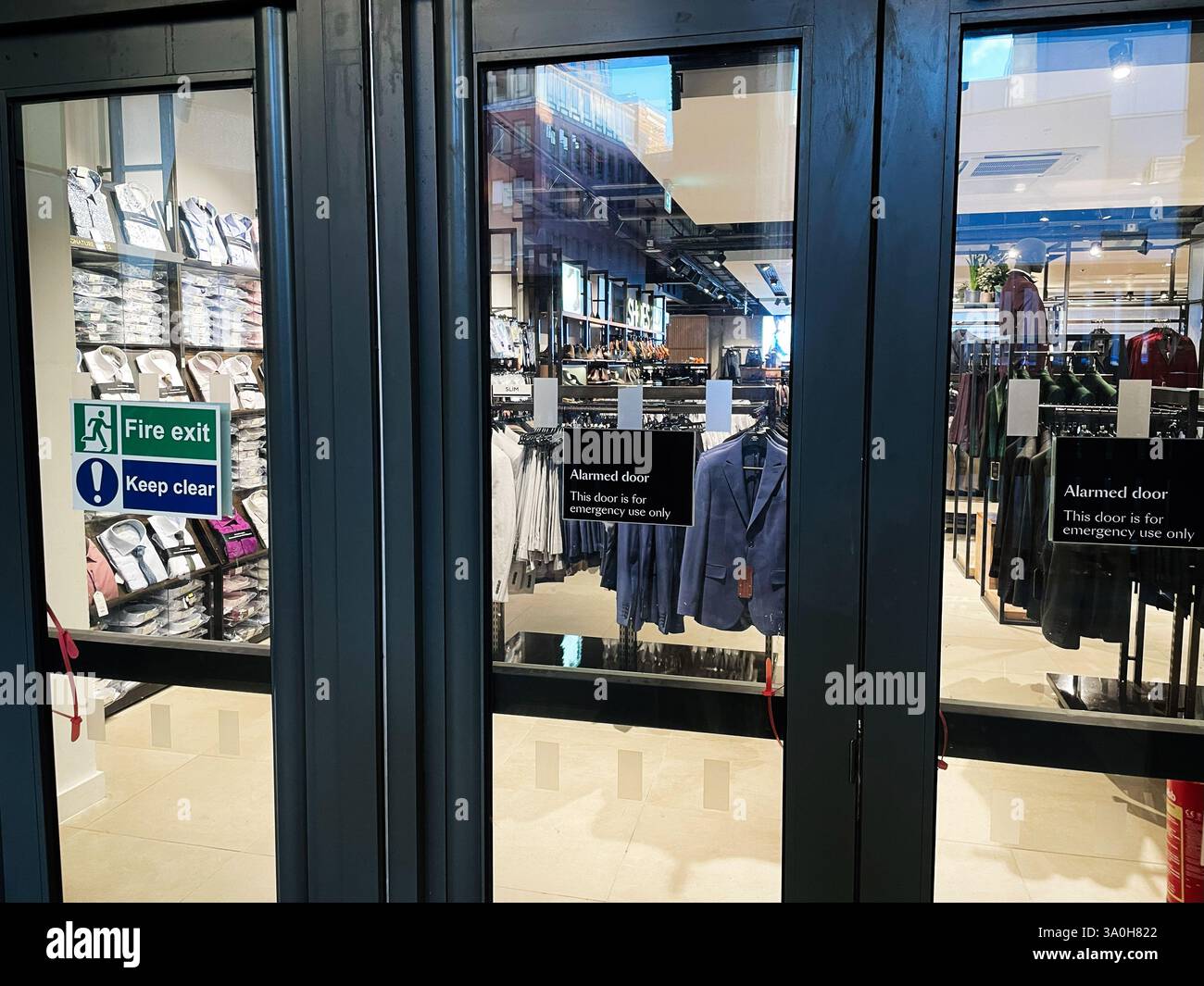 London, UK - March 02, 2025: Glass emergency door in a store showing ...