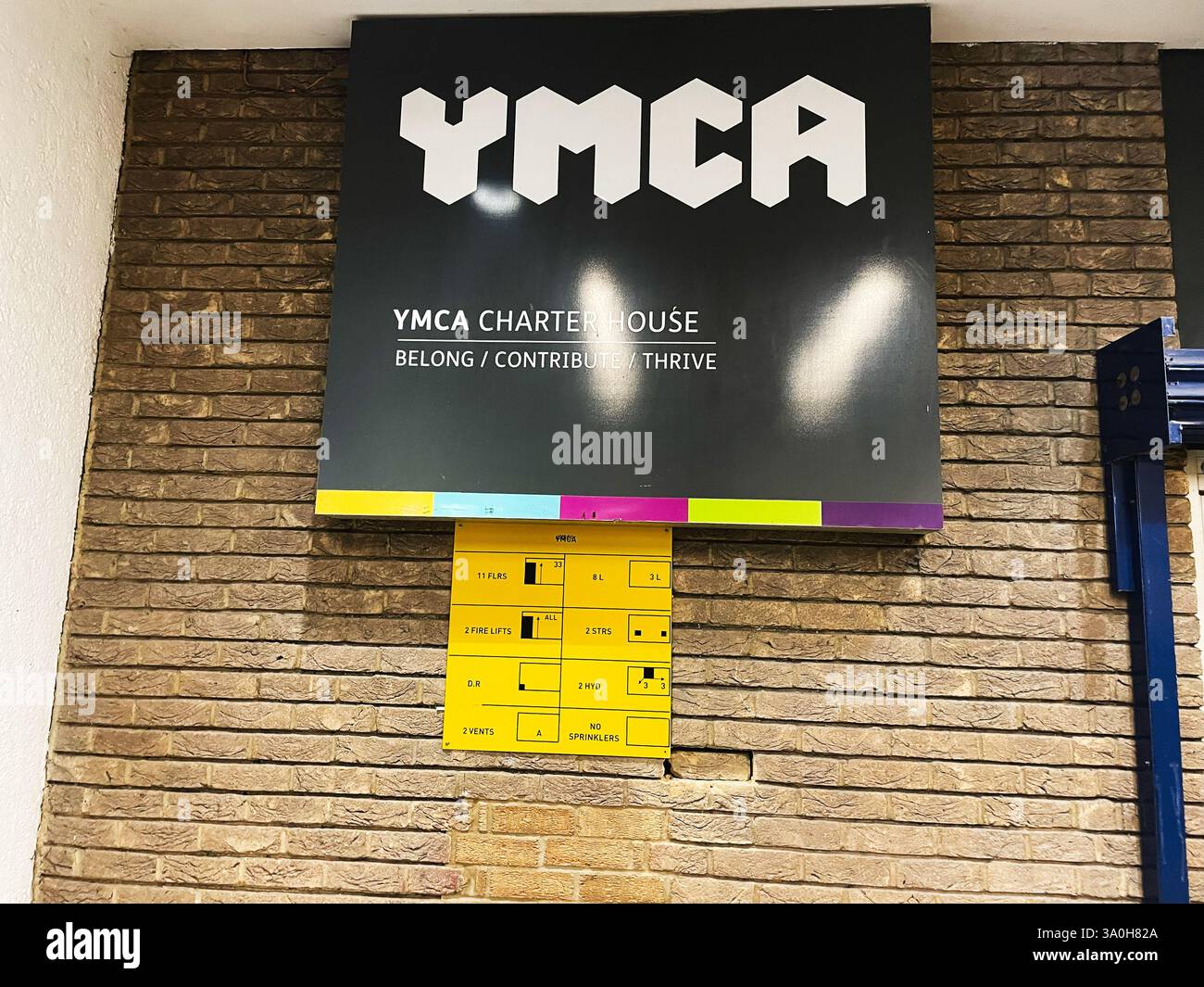 London, UK - March 02, 2025: YMCA sign displayed on a textured brick ...
