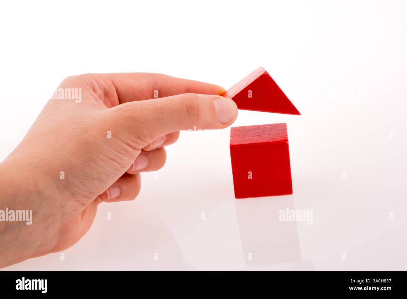 Hand making house with colorful cubes on a white background Stock Photo ...