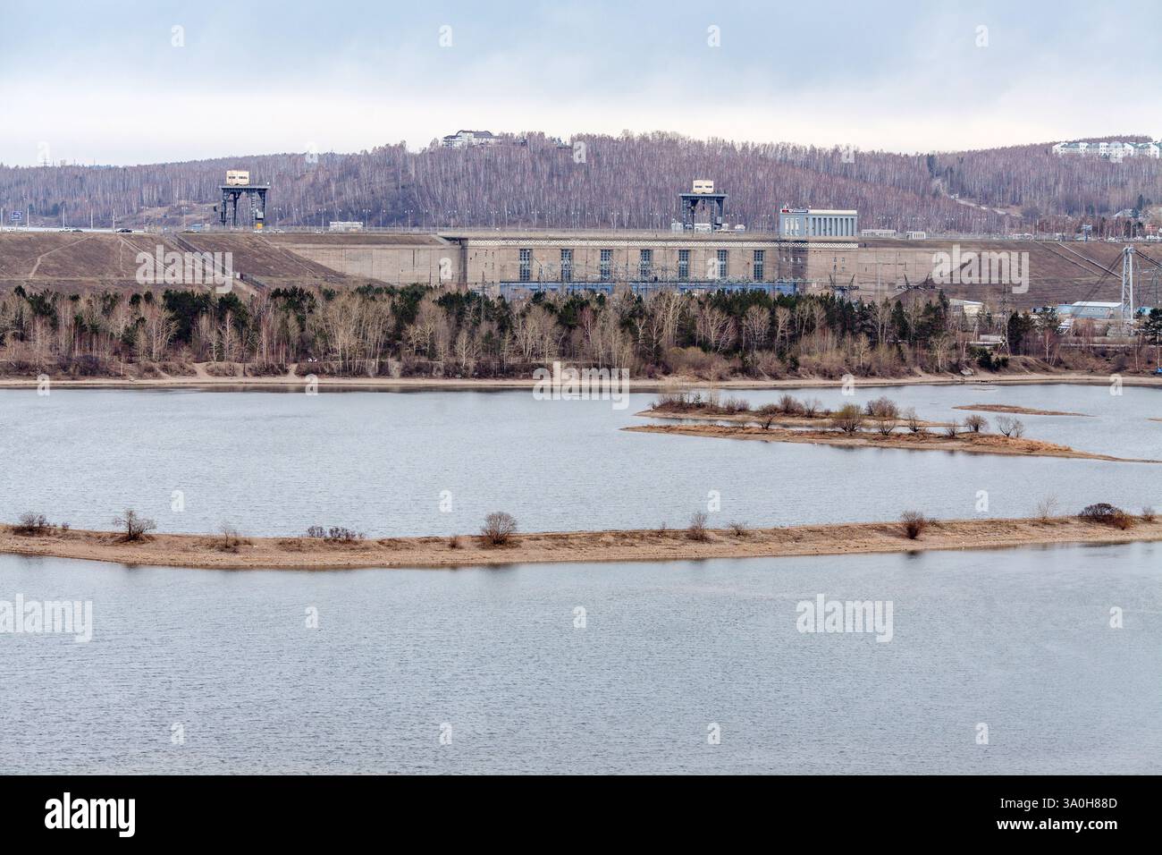 A view of a Irkutsk dam structure across a river, with small islands in ...