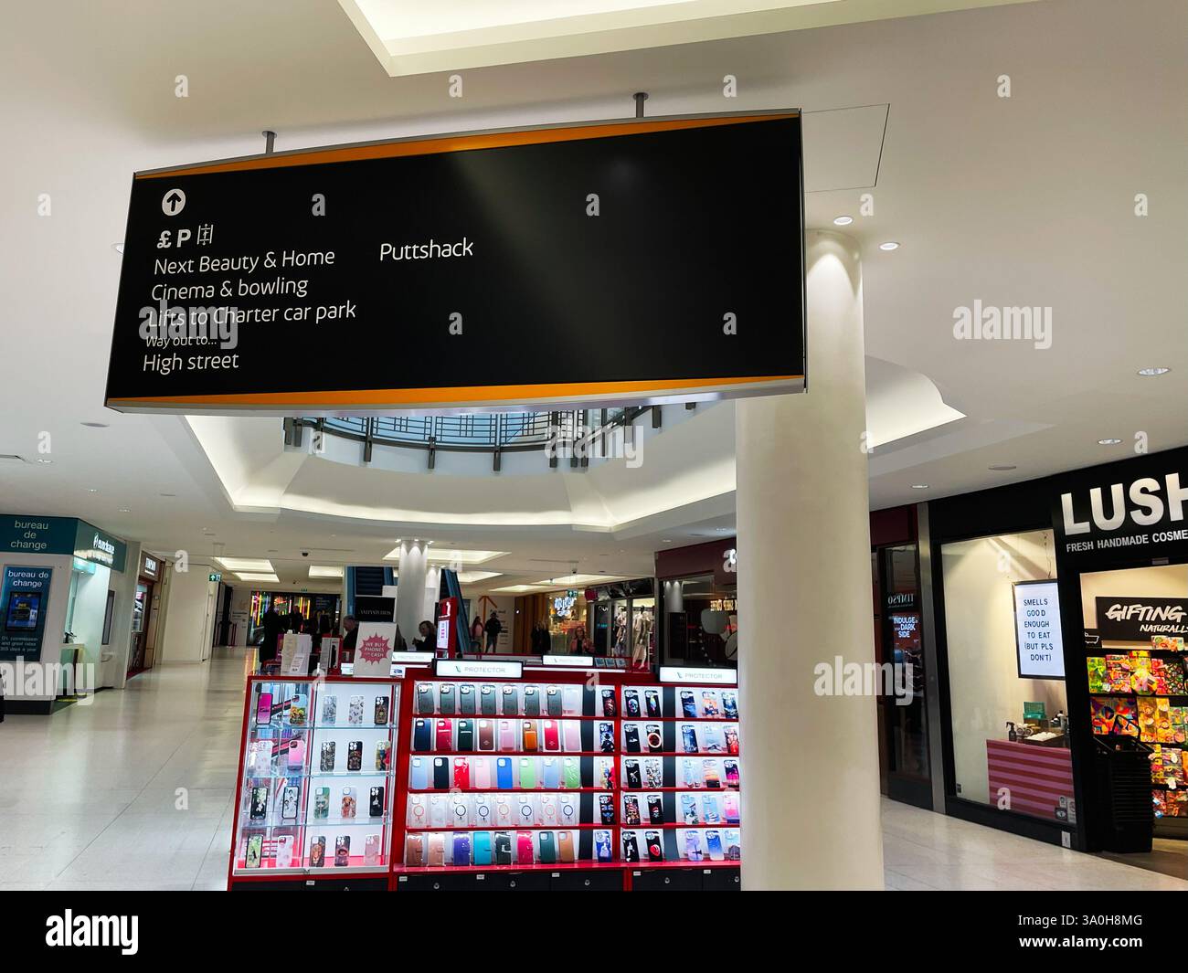 London, UK - March 02, 2025: Spacious shopping mall with a visible directory sign and various ...