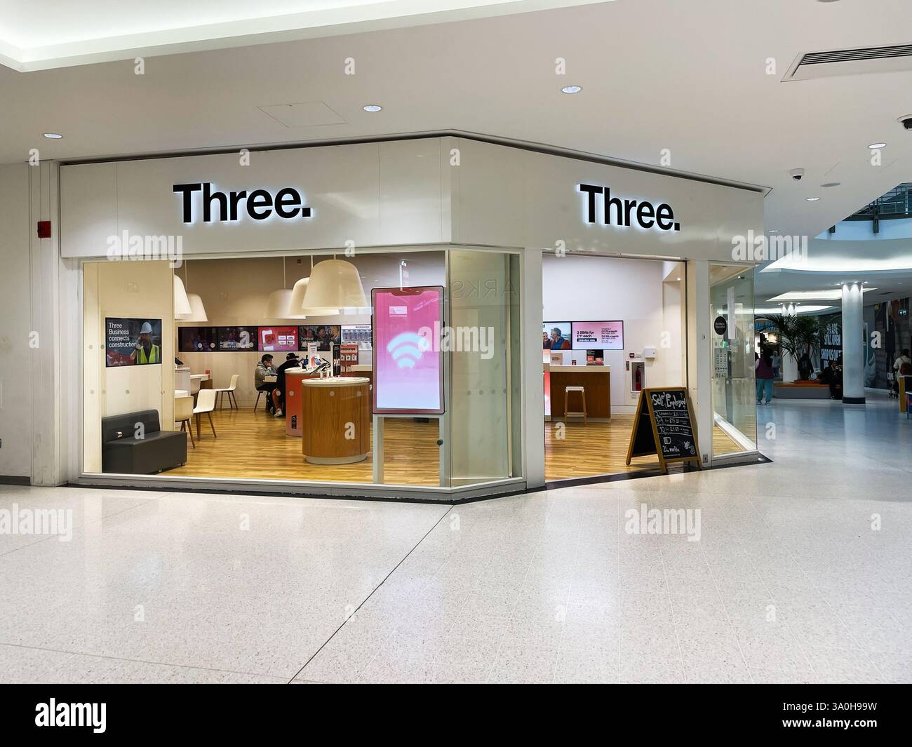 London, UK - March 02, 2025: A telecommunications store with Three ...