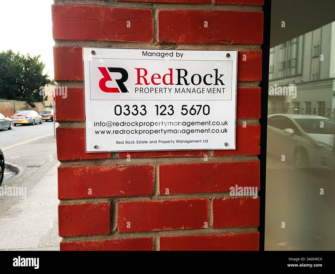 London, UK - March 02, 2025: Brick wall with a fixed sign for Red Rock ...