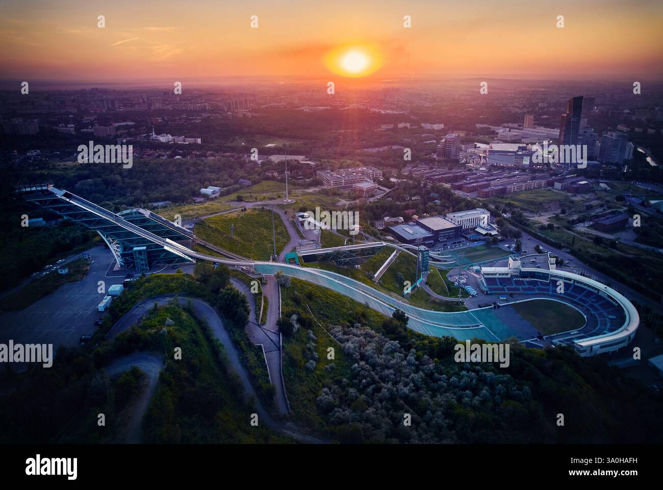 Aerial drone shot of ski jumping complex Sunkar at sunset orange sky in ...