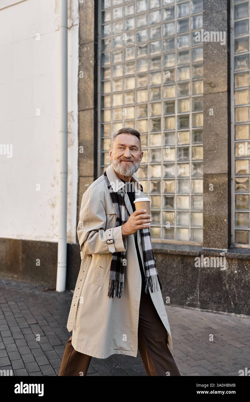 A dapper senior man enjoys a leisurely walk in the city while holding a ...