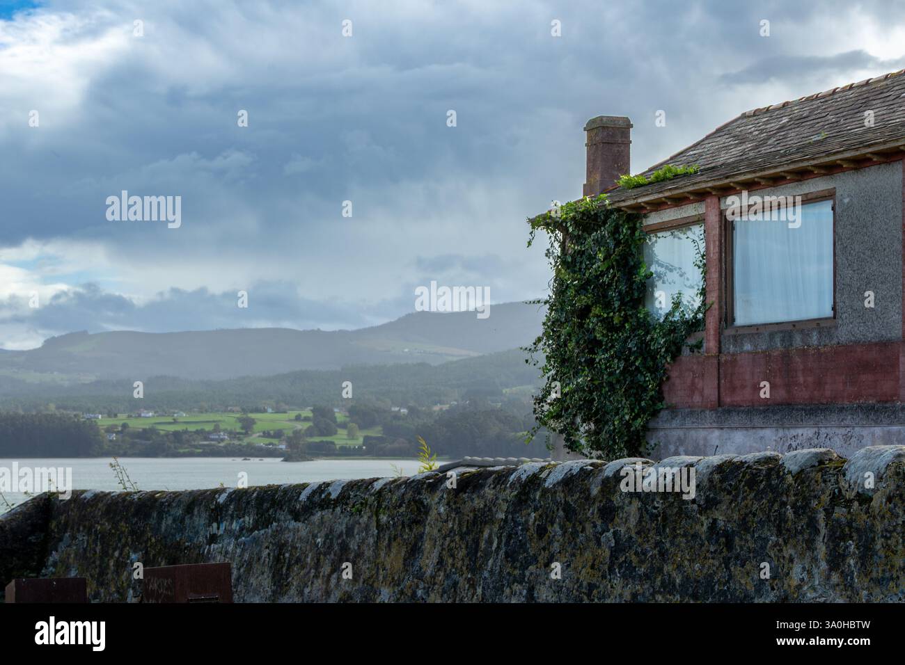 This photograph captures a serene lakeside setting, showcasing an old ...
