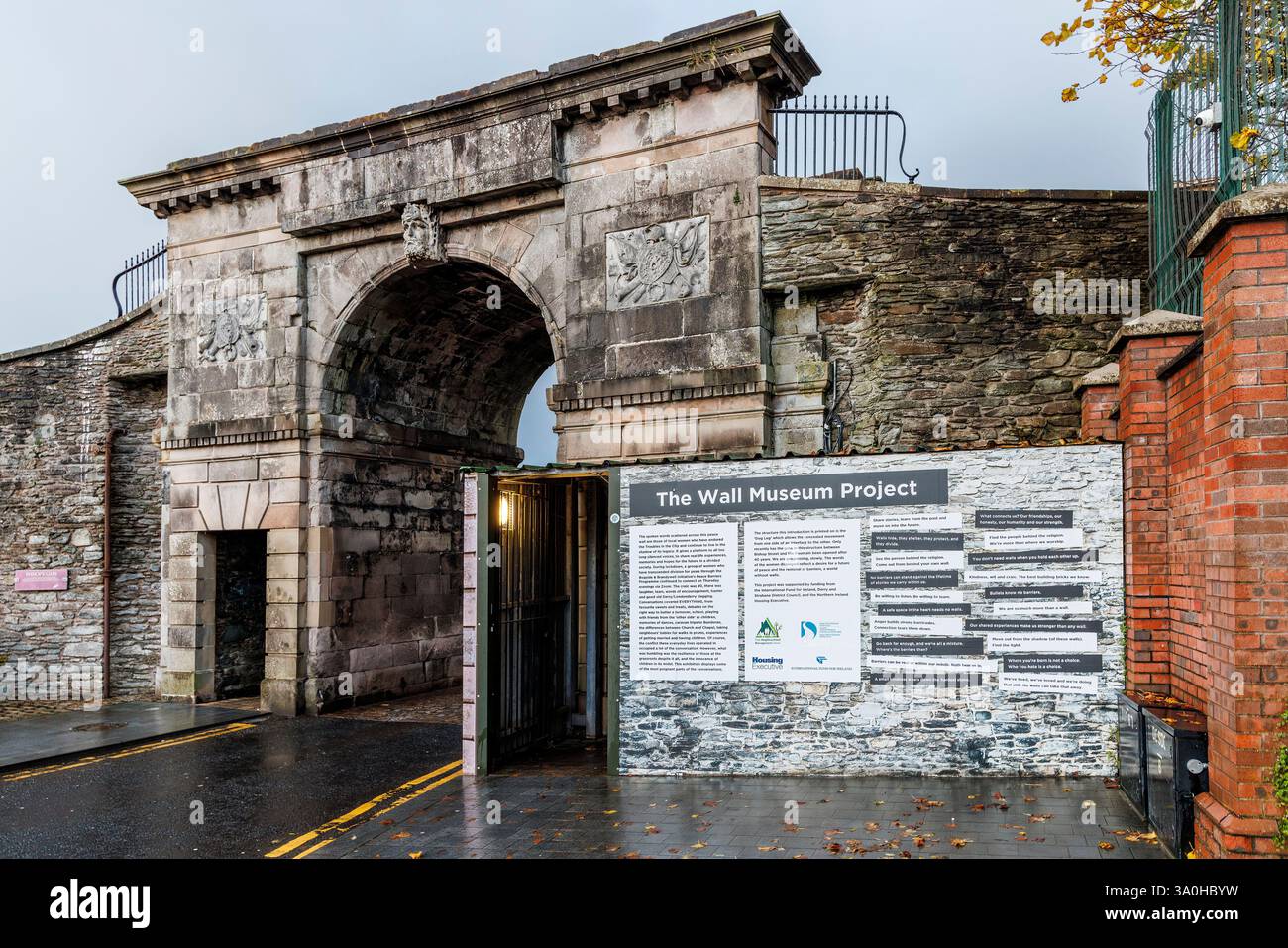 Sign and gate in the city wall and information about the Wall Museum ...