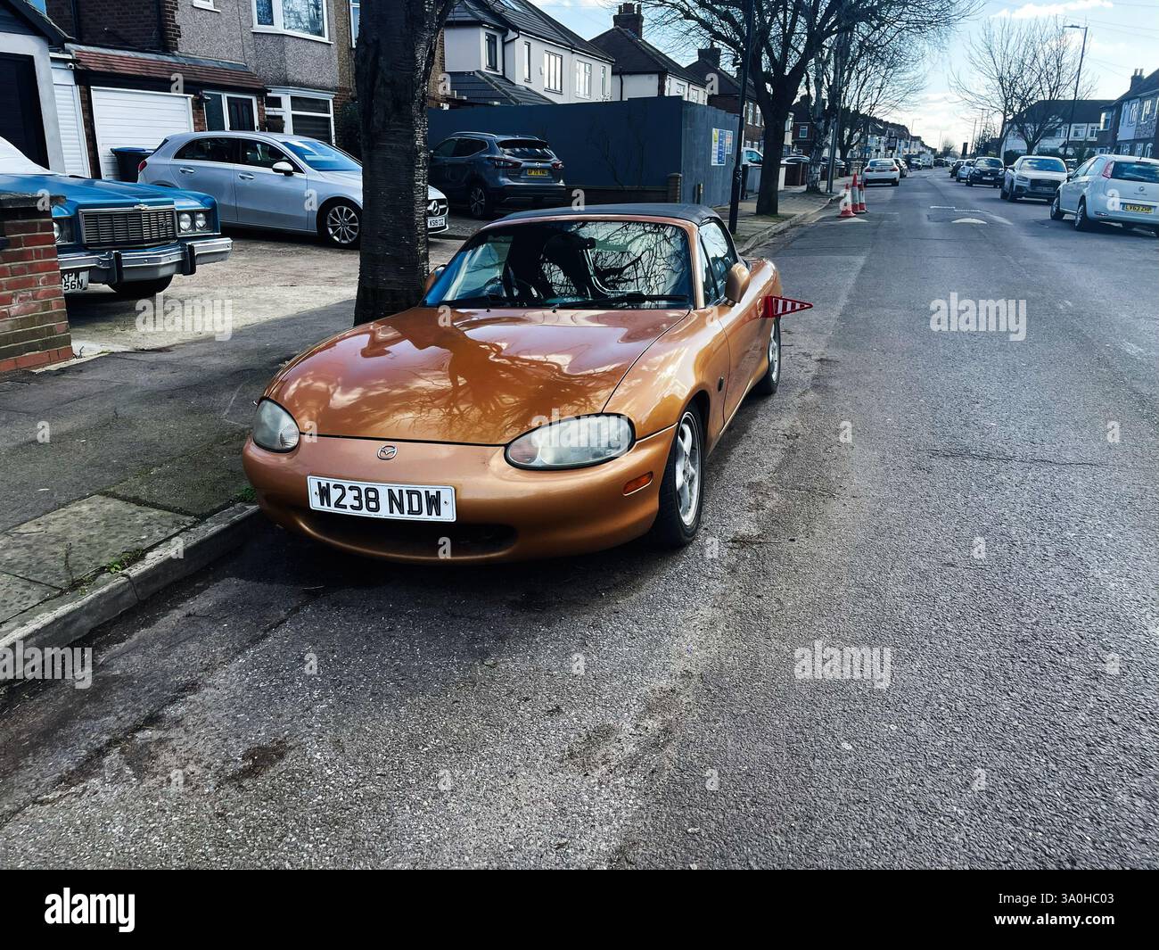 London, UK - March 02, 2025: Orange sports Mazda MX-5 car parked on a ...