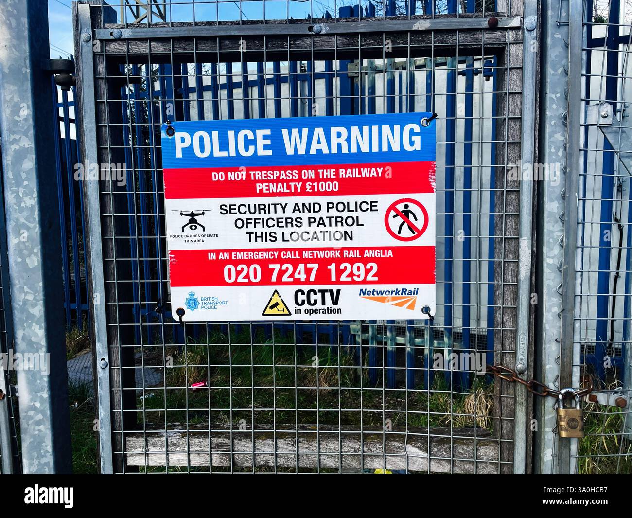 London, UK - March 02, 2025: Metal fence with warning sign regarding ...