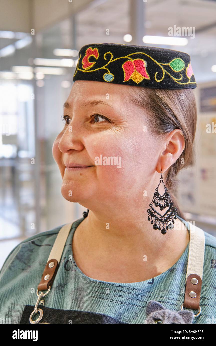 Smiling asian woman wears traditional Tatar embroidered scullcap with ...