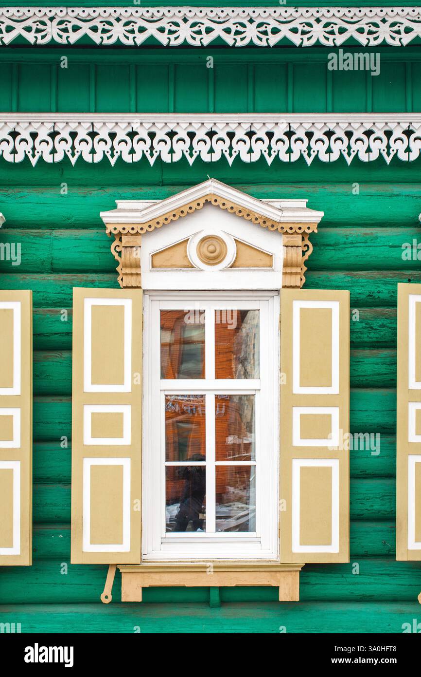 A beautifully restored window of a traditional wooden house with a ...