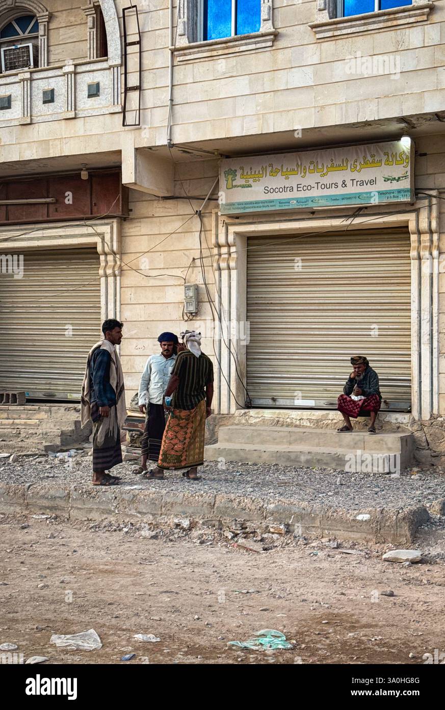 Men engage in conversation outside shuttered stores in Socotra ...