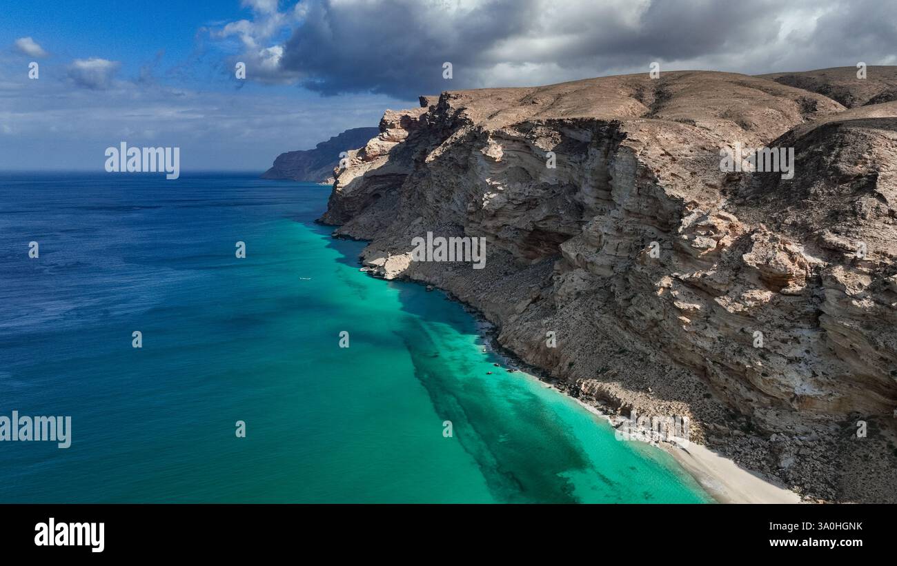 Experience the breathtaking views of Shoab Bay in Socotra, where turquoise waters meet dramatic ...