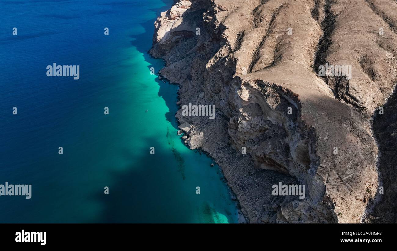 Enjoy a breathtaking sight of Shoab bay in Socotra featuring turquoise waters against steep ...