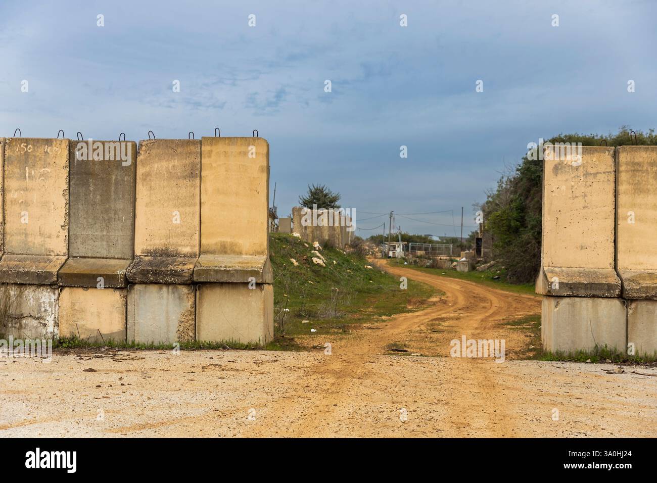 Concrete Security Barrier and Winding Dirt Road Leading into a ...