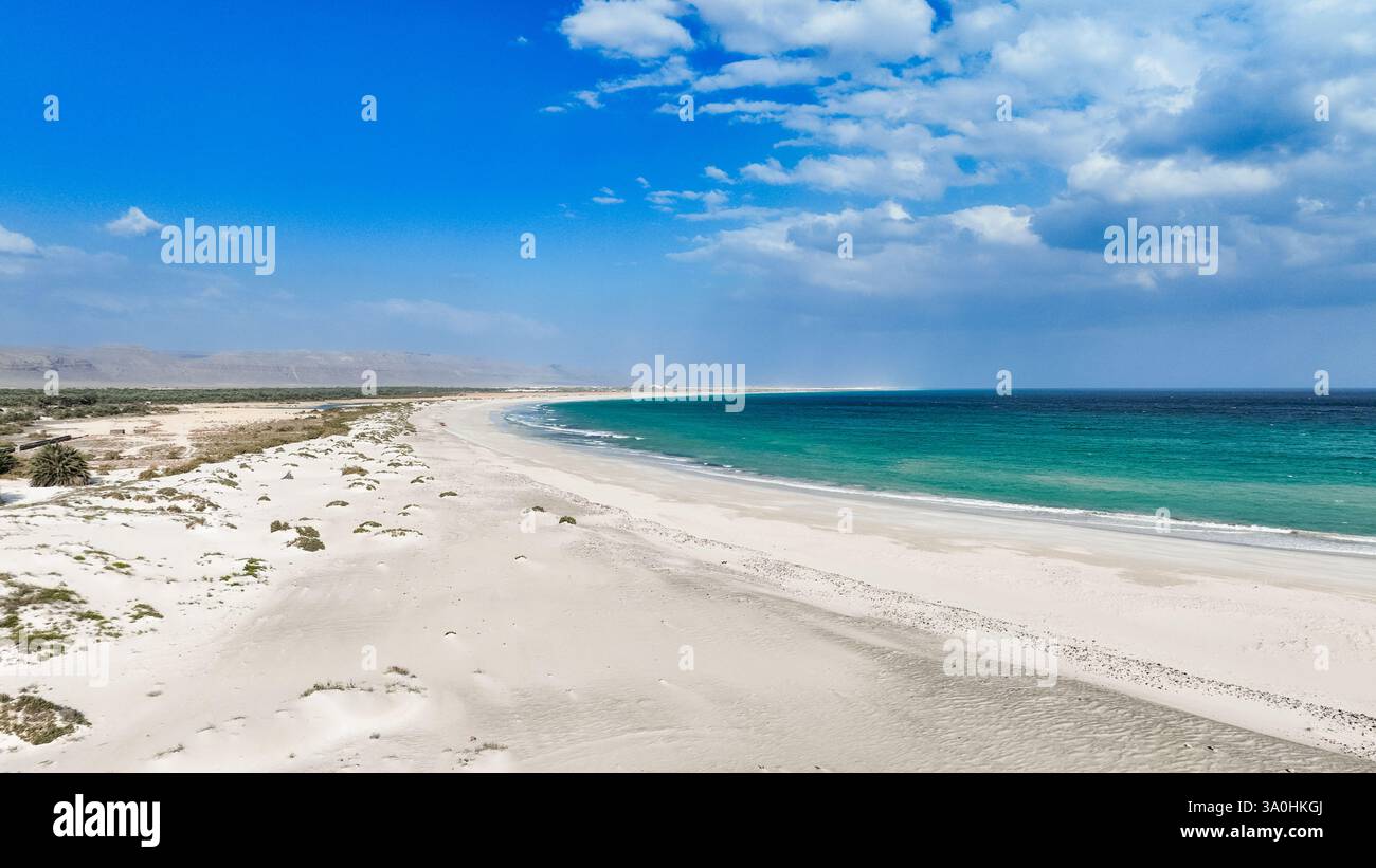 Vast white sandy beaches meet vivid turquoise waters under a bright ...