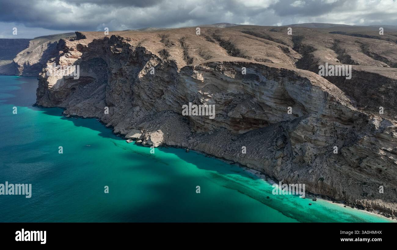 Majestic cliffs rise above the vibrant turquoise waters of Socotra ...