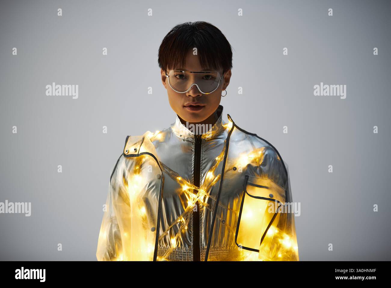A dapper young Asian man showcases fashion flair while emitting an aura ...