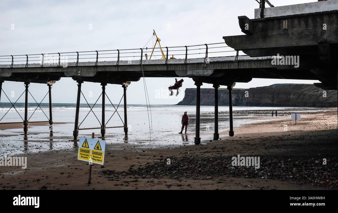 Workmen carrying out maintenance work beneath the pier at Saltburn by ...