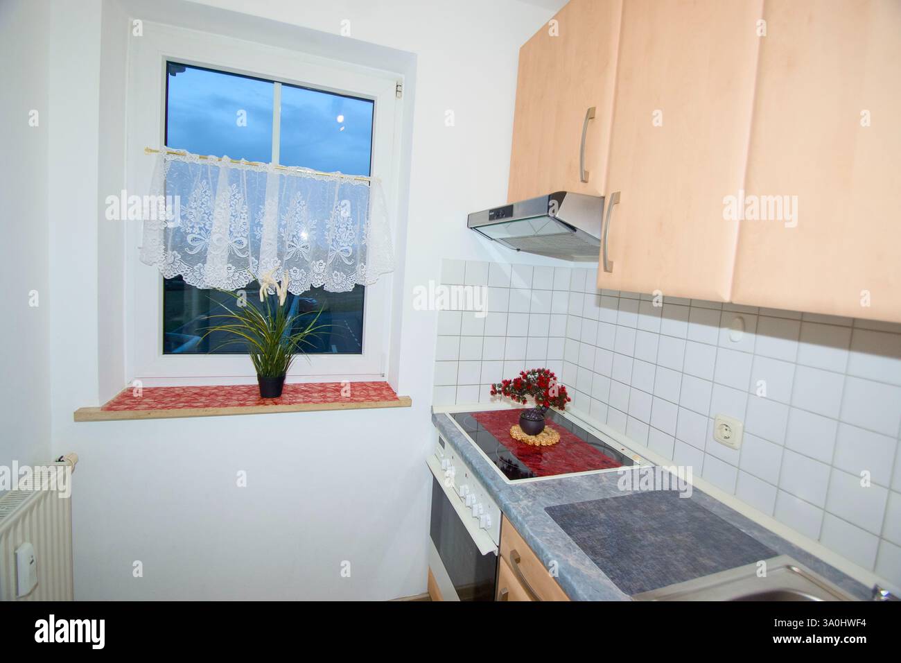 A typical small kitchen in a simple German apartment, featuring basic ...