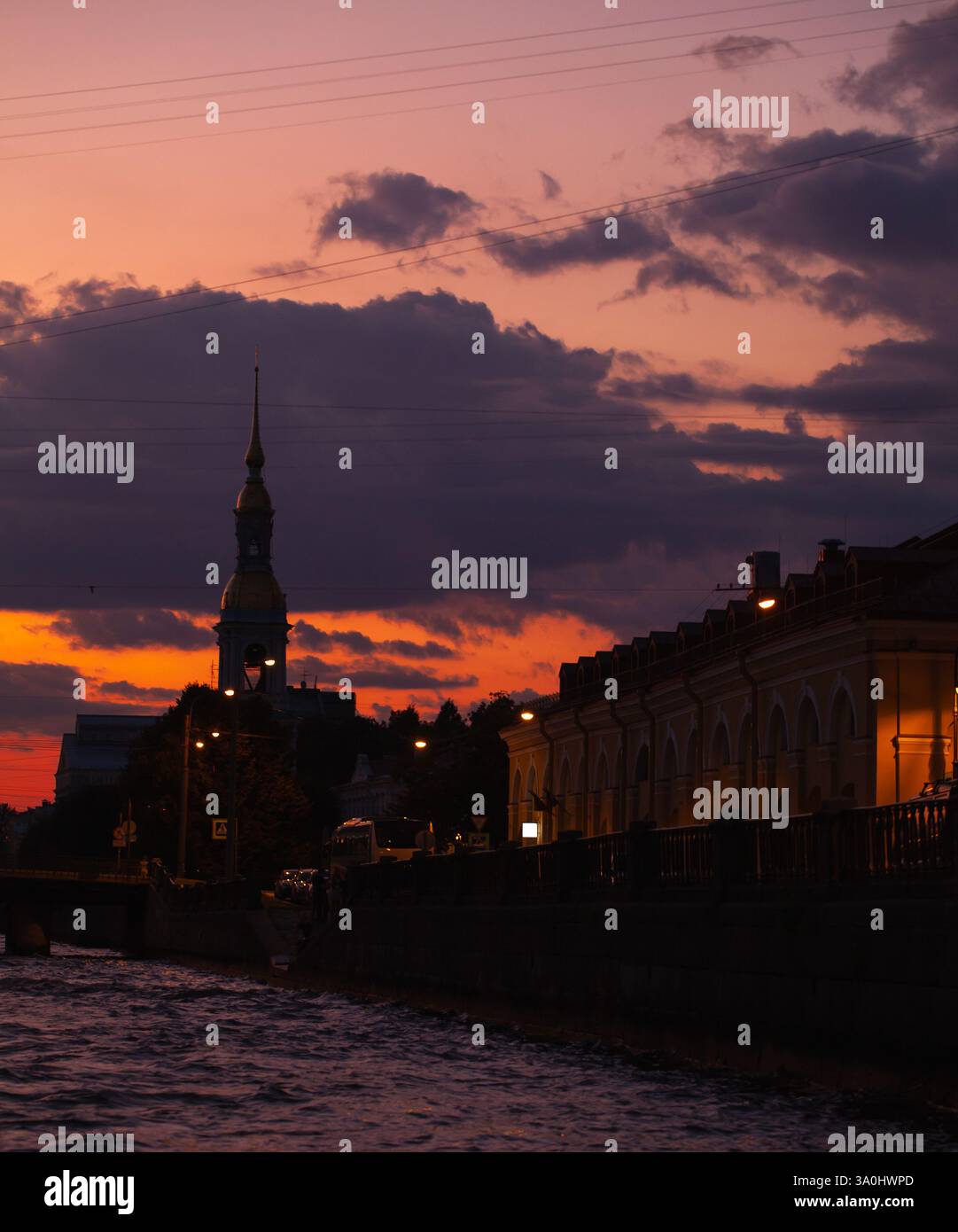 A picturesque sunset scene featuring a river, a silhouette of Baroque ...