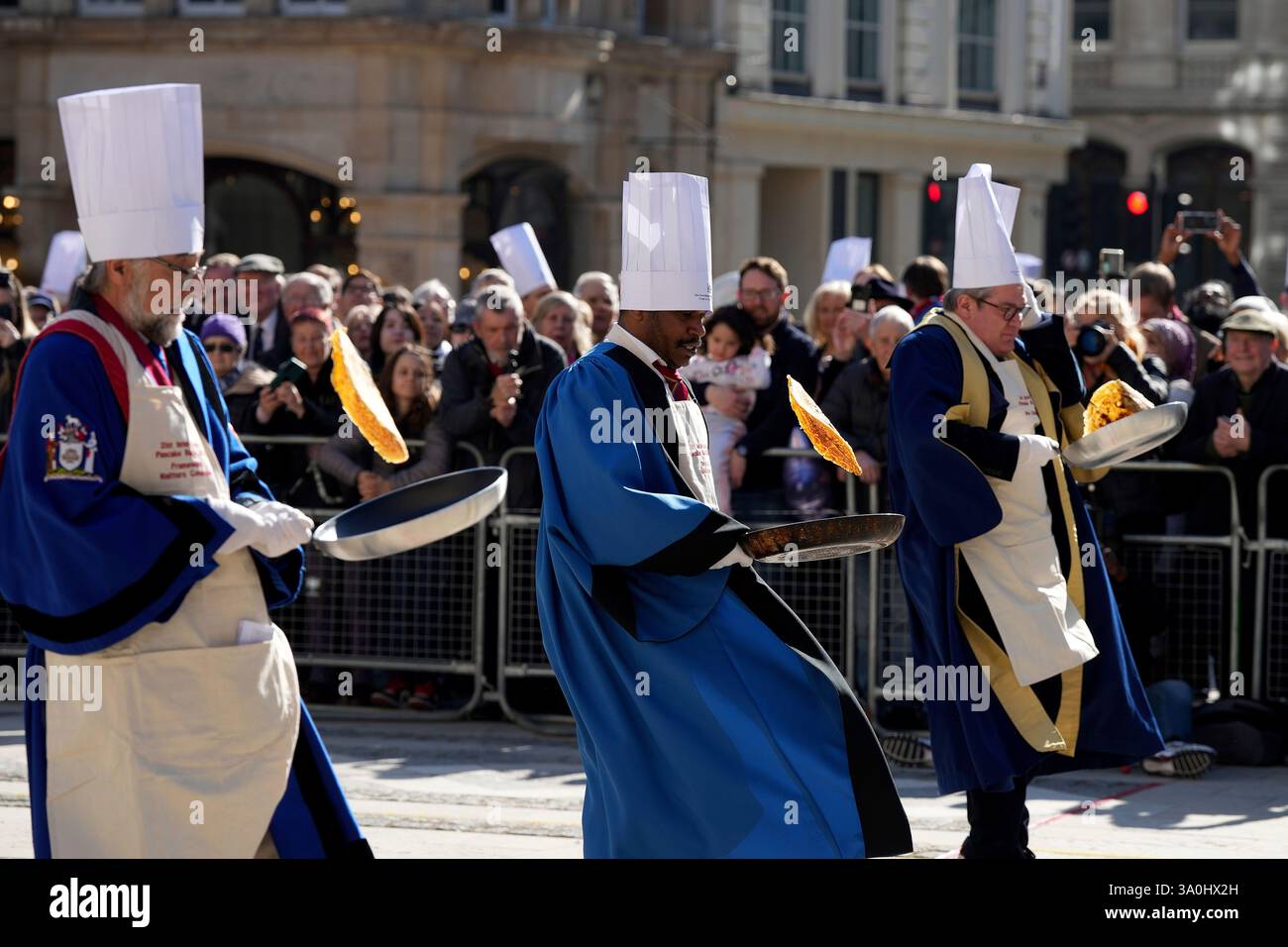 Runners compete during a traditional pancake race by livery companies ...