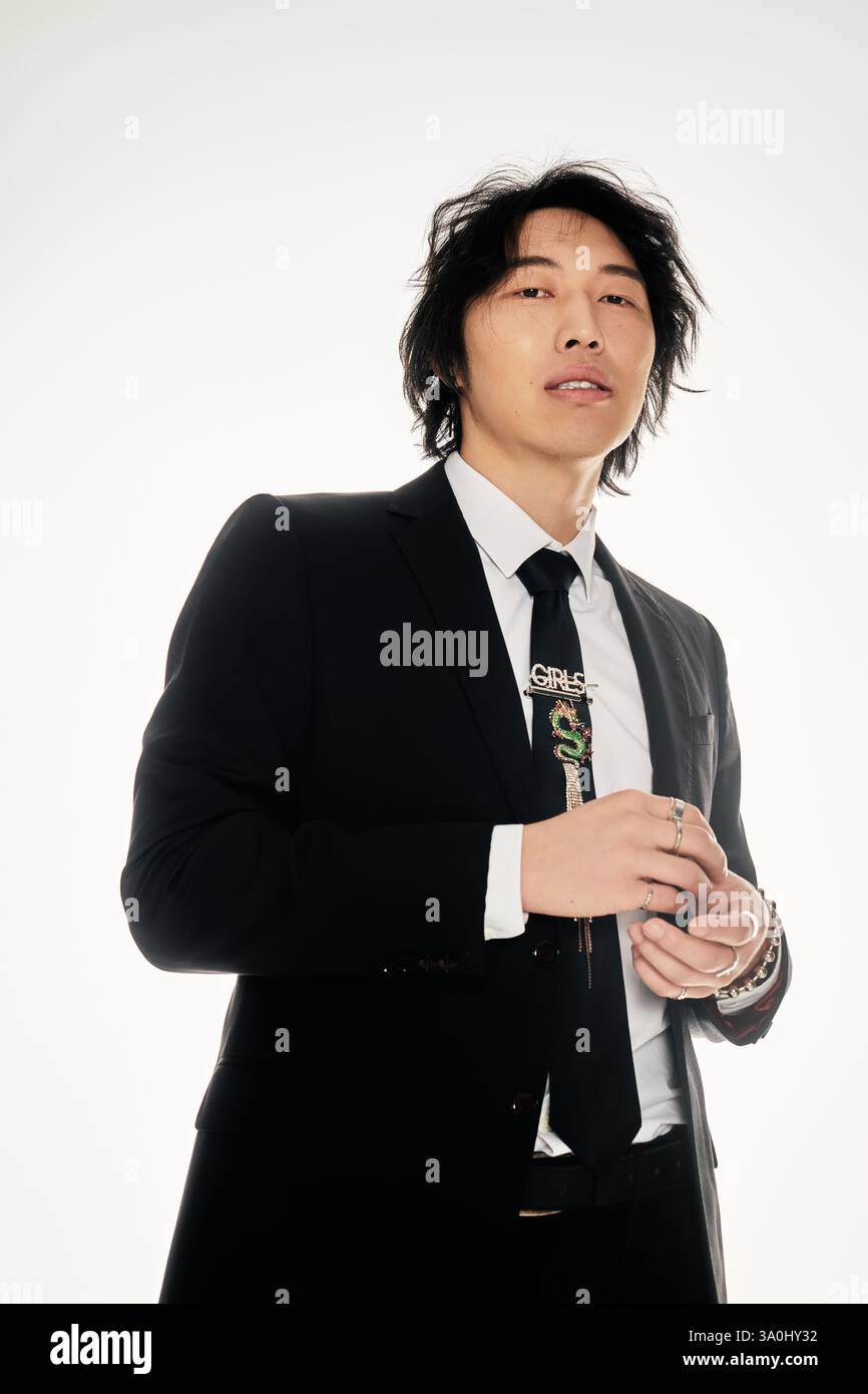 Confident young man showcases modern fashion with chic style in a ...