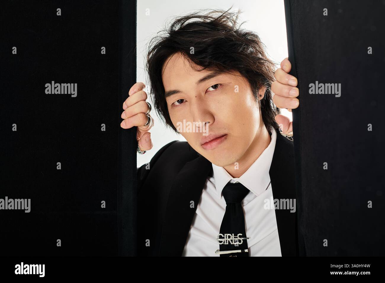 Chic young asian male confidently posing in fashionable attire against ...