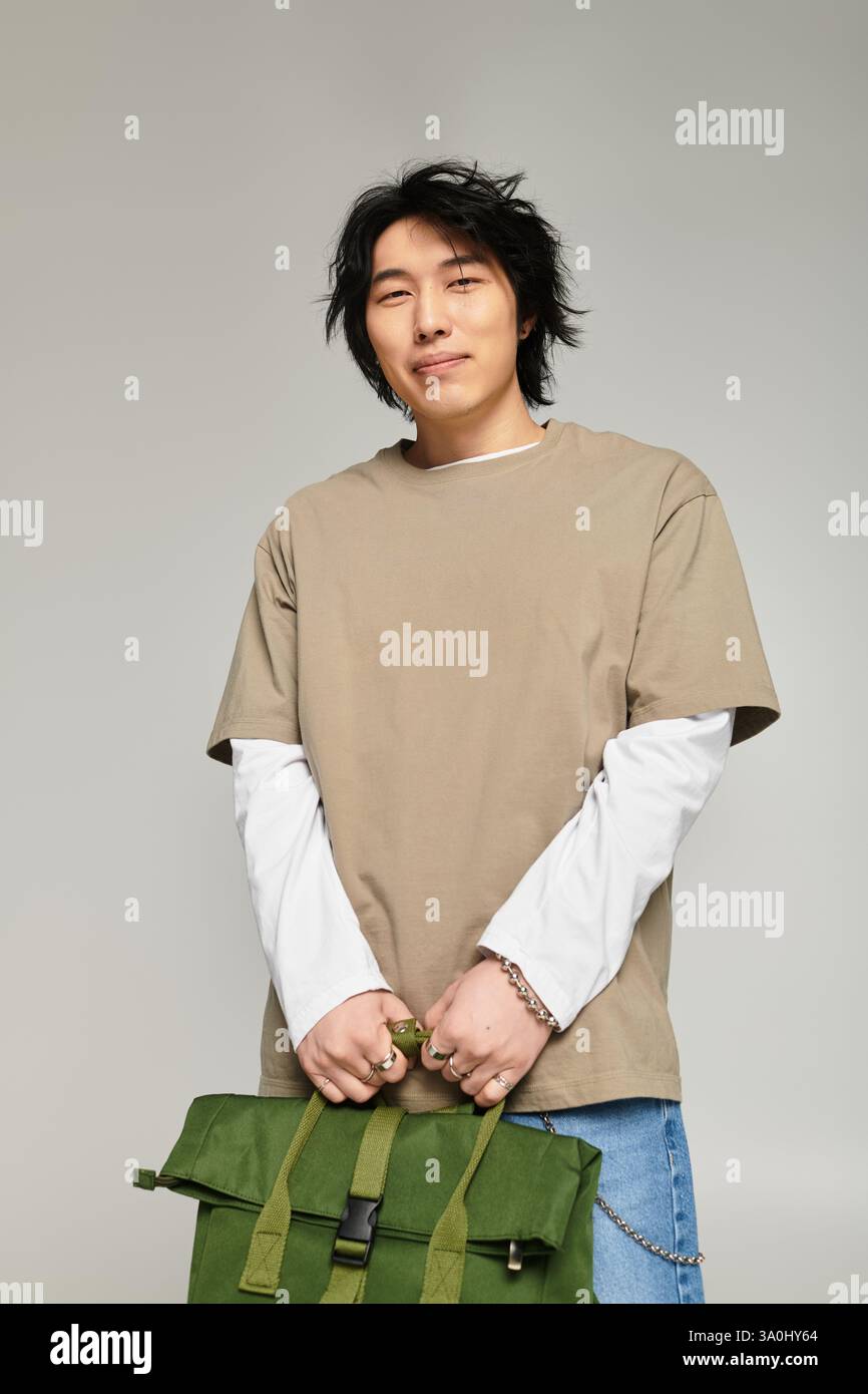 Handsome young asian male showcases trendy fashion while striking a ...