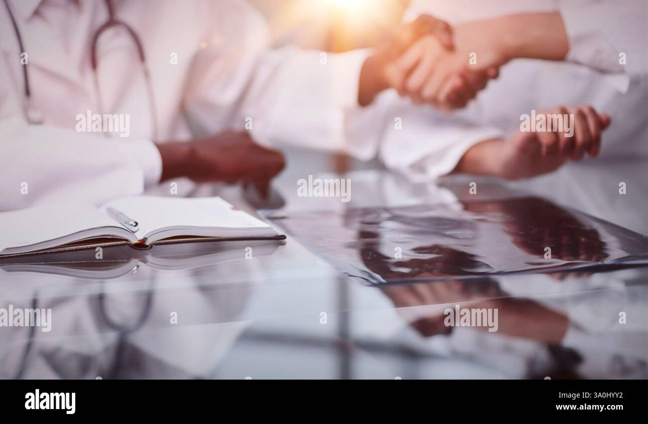 Close up two doctors colleagues shaking hands, greeting Stock Photo - Alamy
