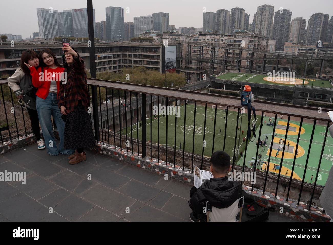 Visitors pose for photos at the West Village project by Pritzker ...