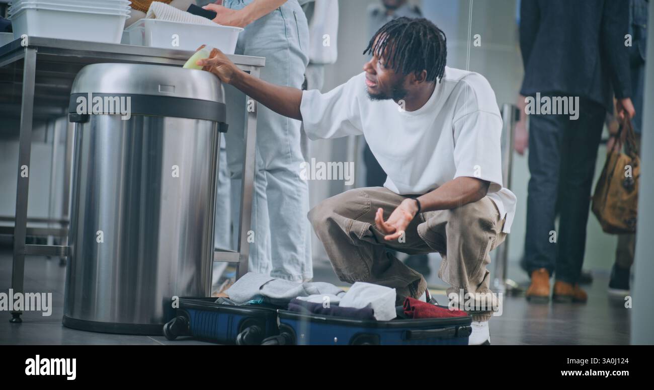 Airport Security Checkpoint: African American Man Removes Liquids from ...