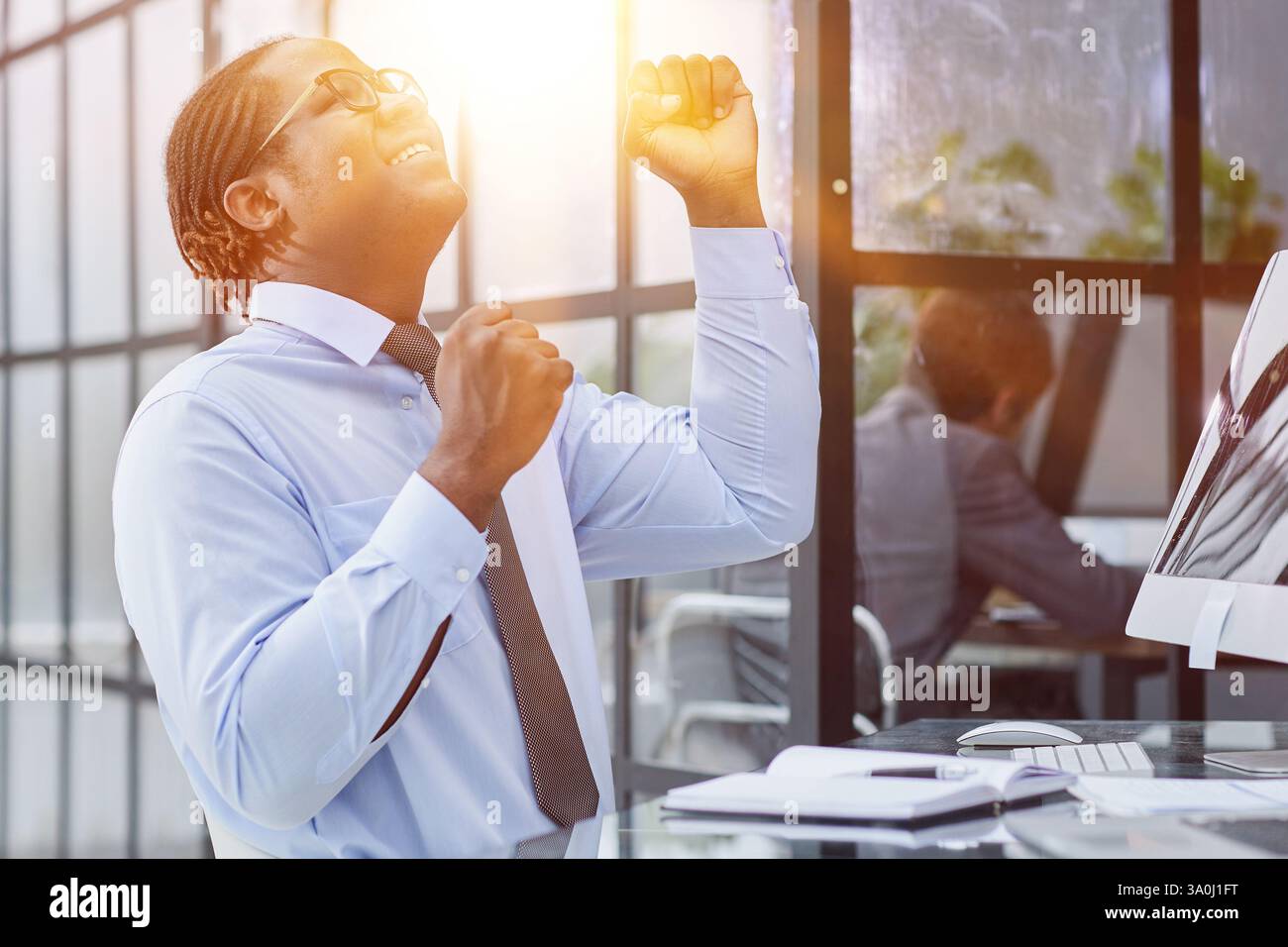 happy man working in the office. raised his hands joyfully Stock Photo ...