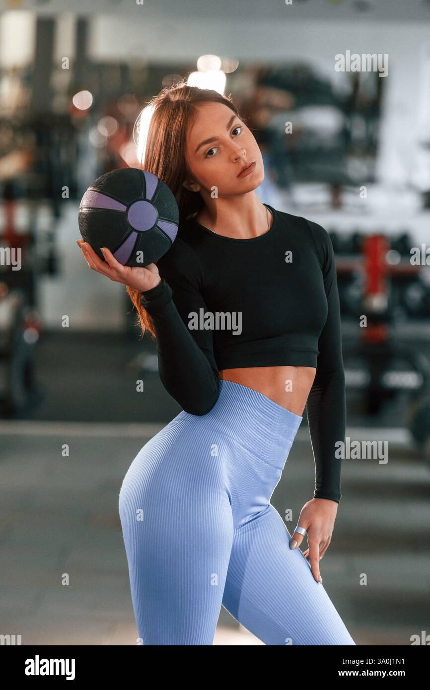 Showing sportive type body. Beautiful woman is in the gym Stock Photo ...