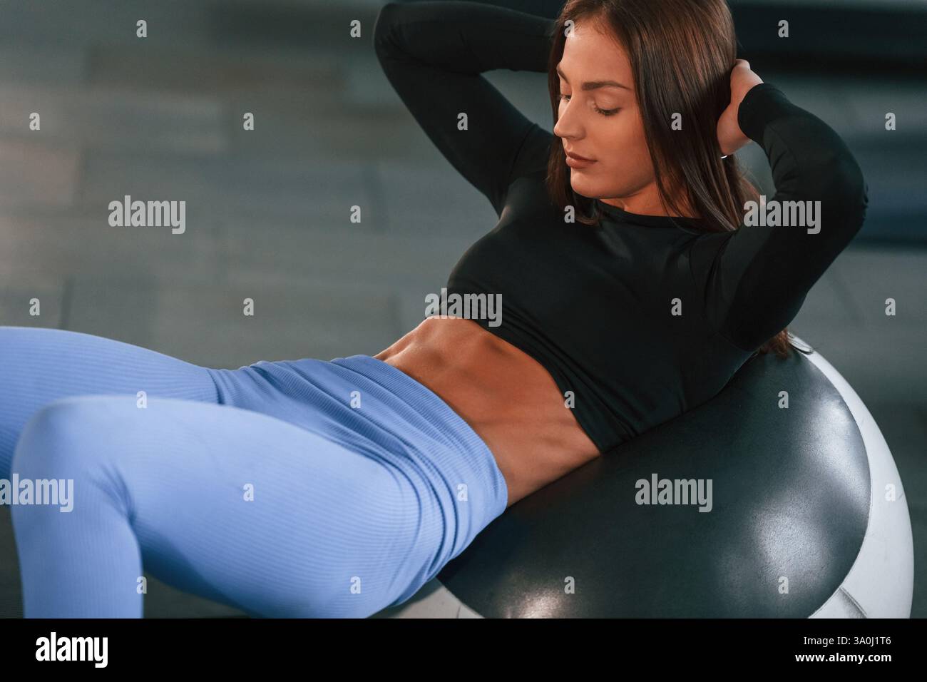 Showing abs. Beautiful woman with sport body type is in the gym Stock ...