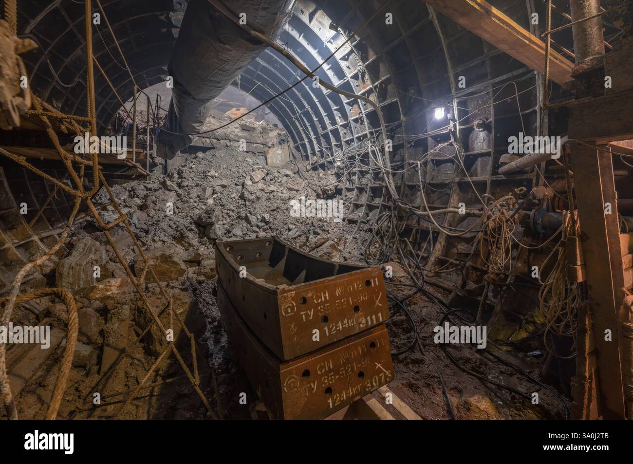 Ground rubble at a subway construction site subway. Cast-iron tubing ...