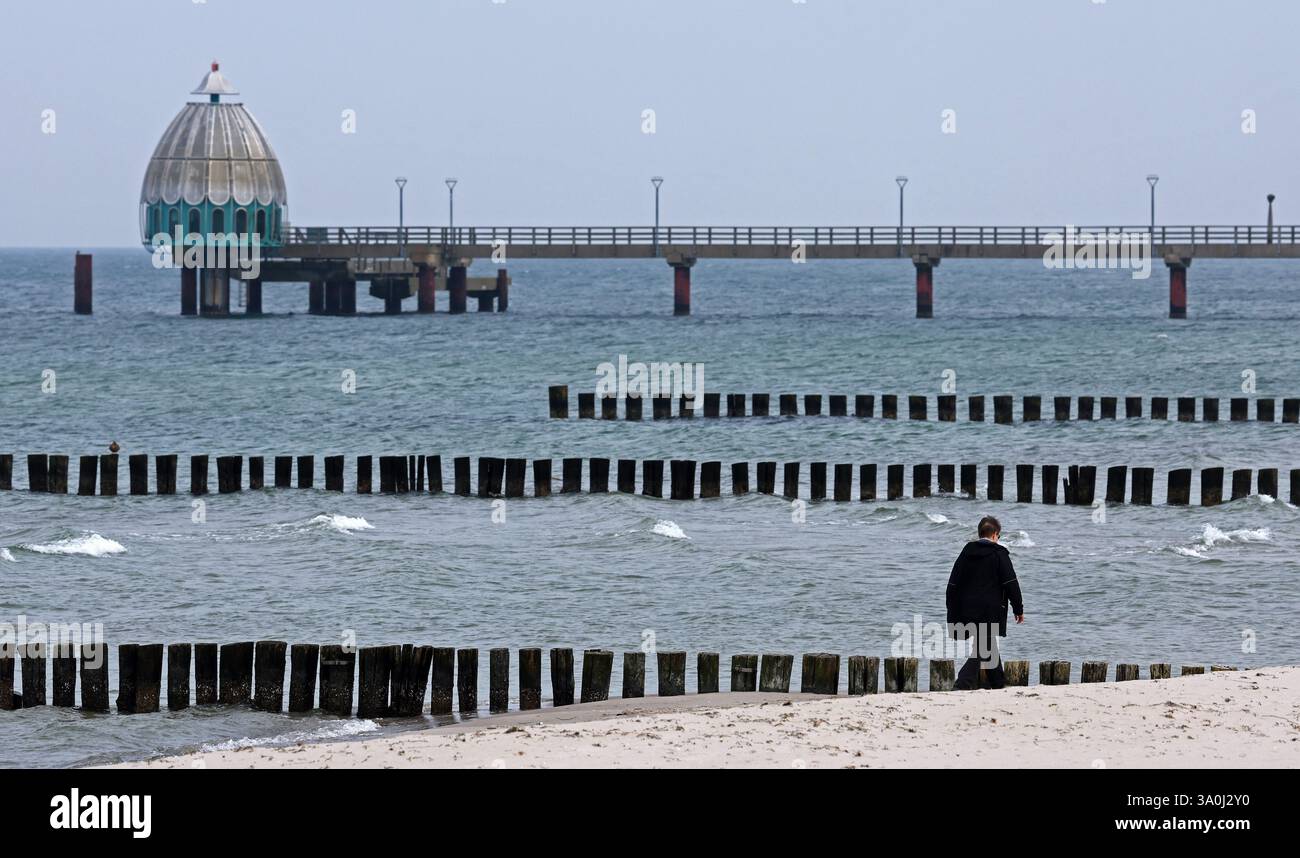 Zingst, Germany. 04th Mar, 2025. A walker on the Baltic Sea beach in ...