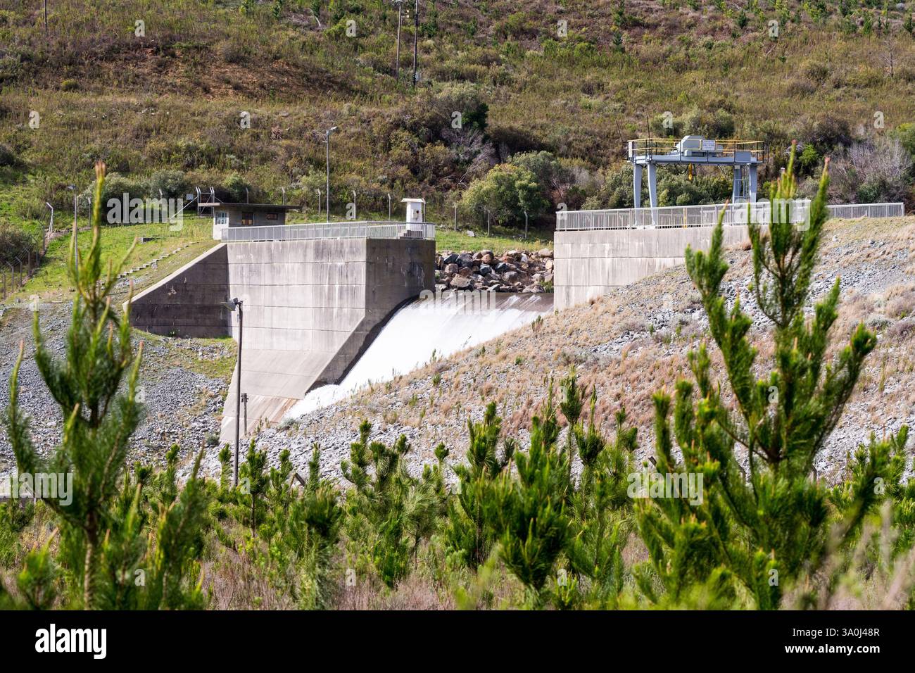 open sluice gates and water gushing out from mountain dam in ...