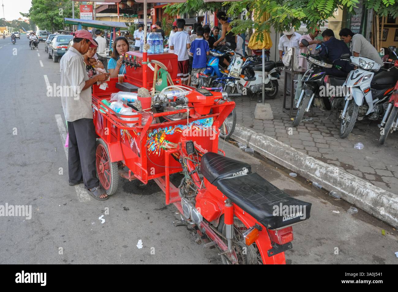 Phnom Penh, Cambodia - May 6, 2009: A street vendor operates a vibrant ...
