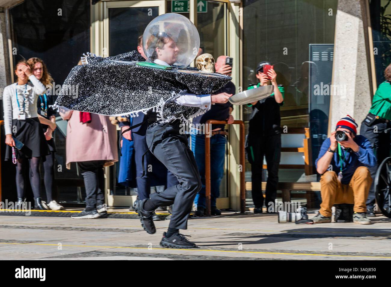 London, UK. 4 Mar 2025. An actuary dressed as a fortune tellers table ...