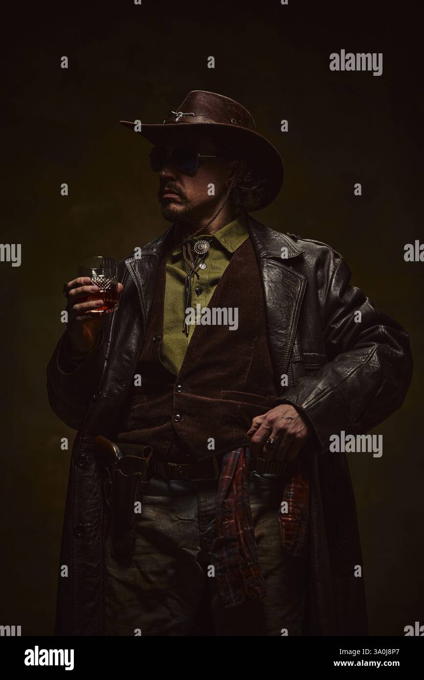 Dark and moody portrait of man, cowboy in leather coat and vest ...