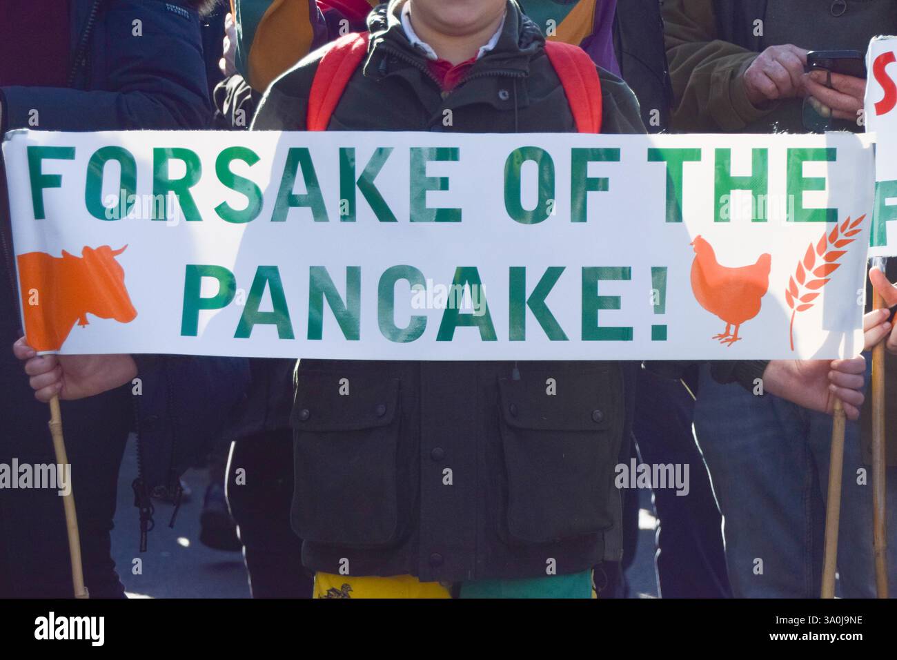 March 4, 2025, London, England, UK: A protester holds a pancake-related ...