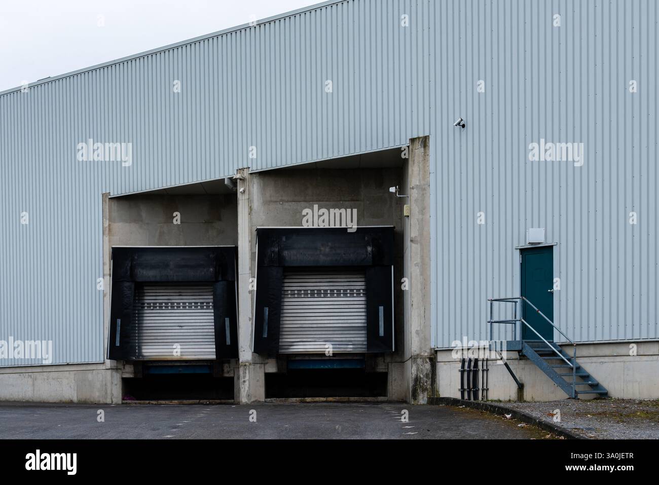 Two loading docks lie side by side at a commercial warehouse under an ...
