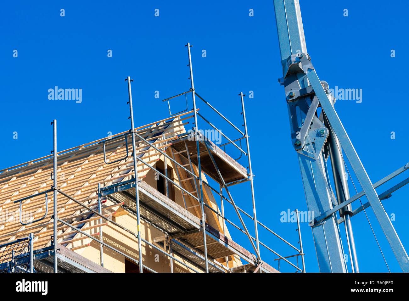 Work continues on a building under construction, featuring scaffolding ...