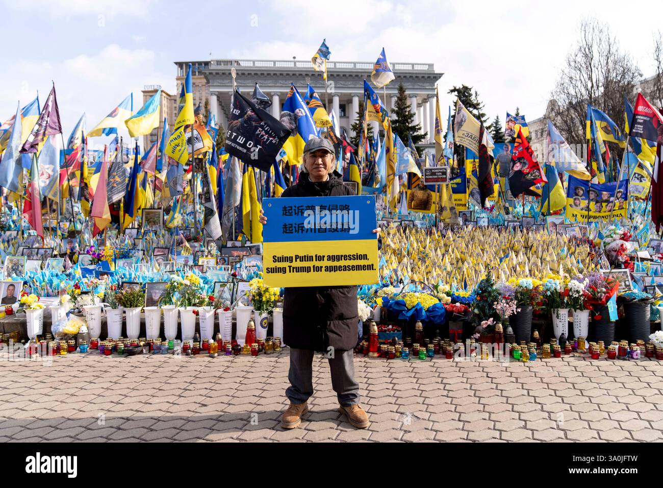 Protester from China in front of flags and candles seen at Independence ...