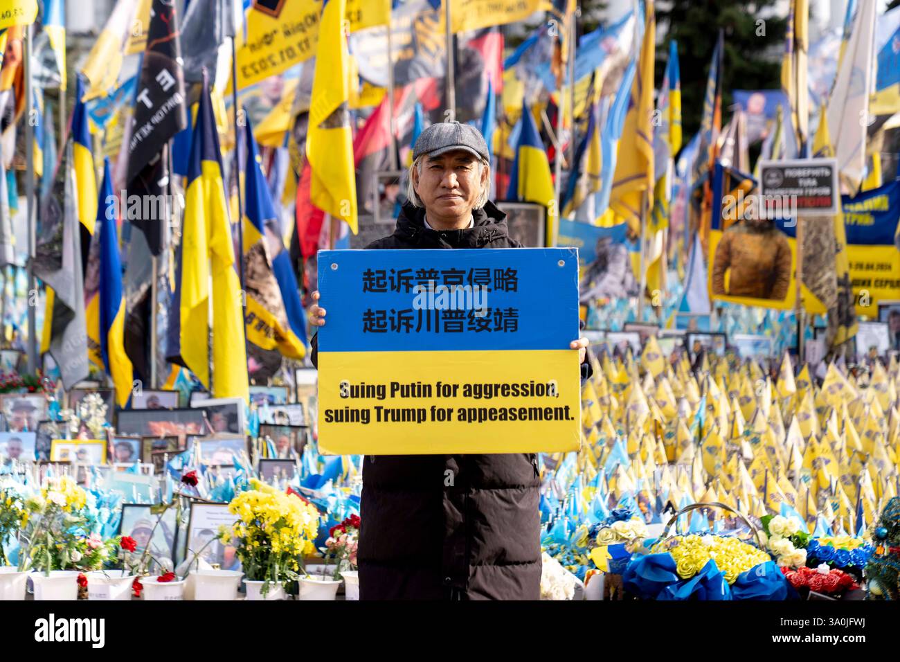 Protester from China in front of flags and candles seen at Independence ...