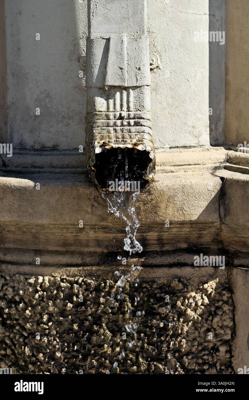 Water flows from a pipe in a street of the city. Rain in the city Stock ...