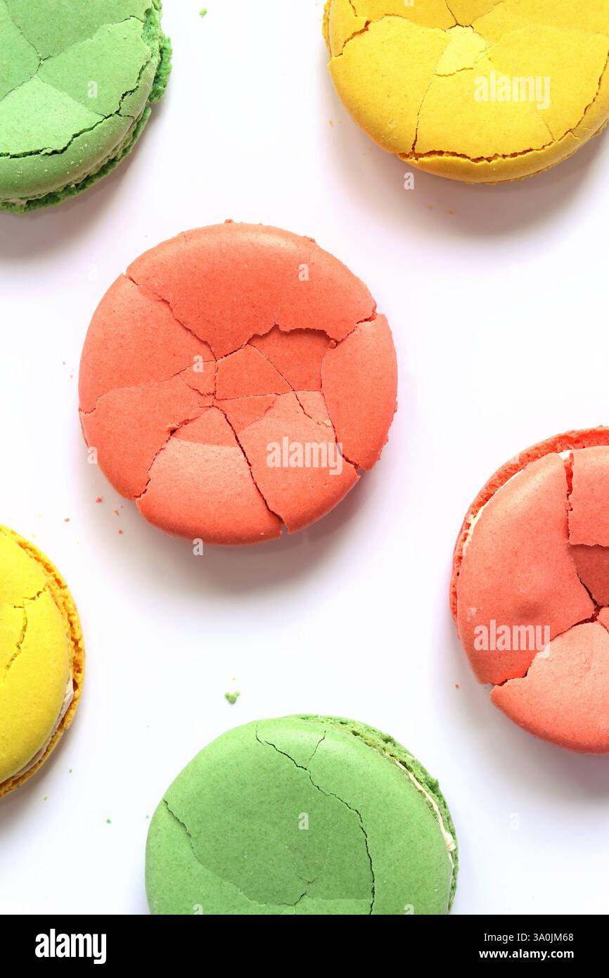 Bright multi-colored French macarons on a light background, top view ...