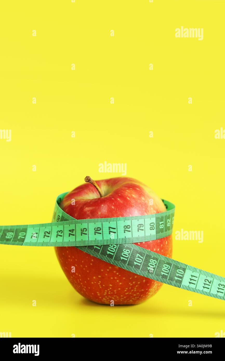 Measuring tape wrapped around an apple. Metaphor - round figure. Ripe ...