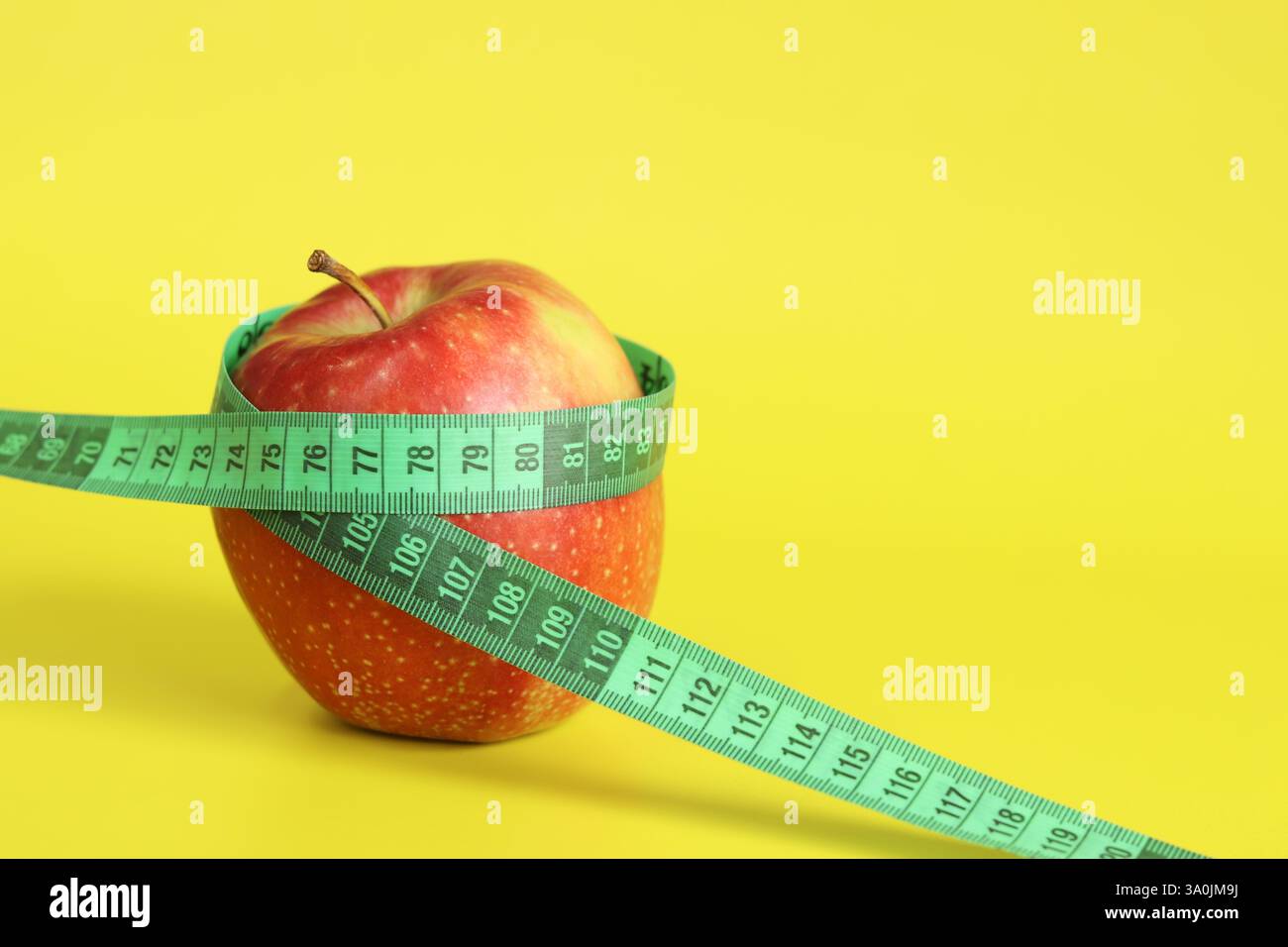 Measuring tape wrapped around an apple. Metaphor - round figure. Ripe ...